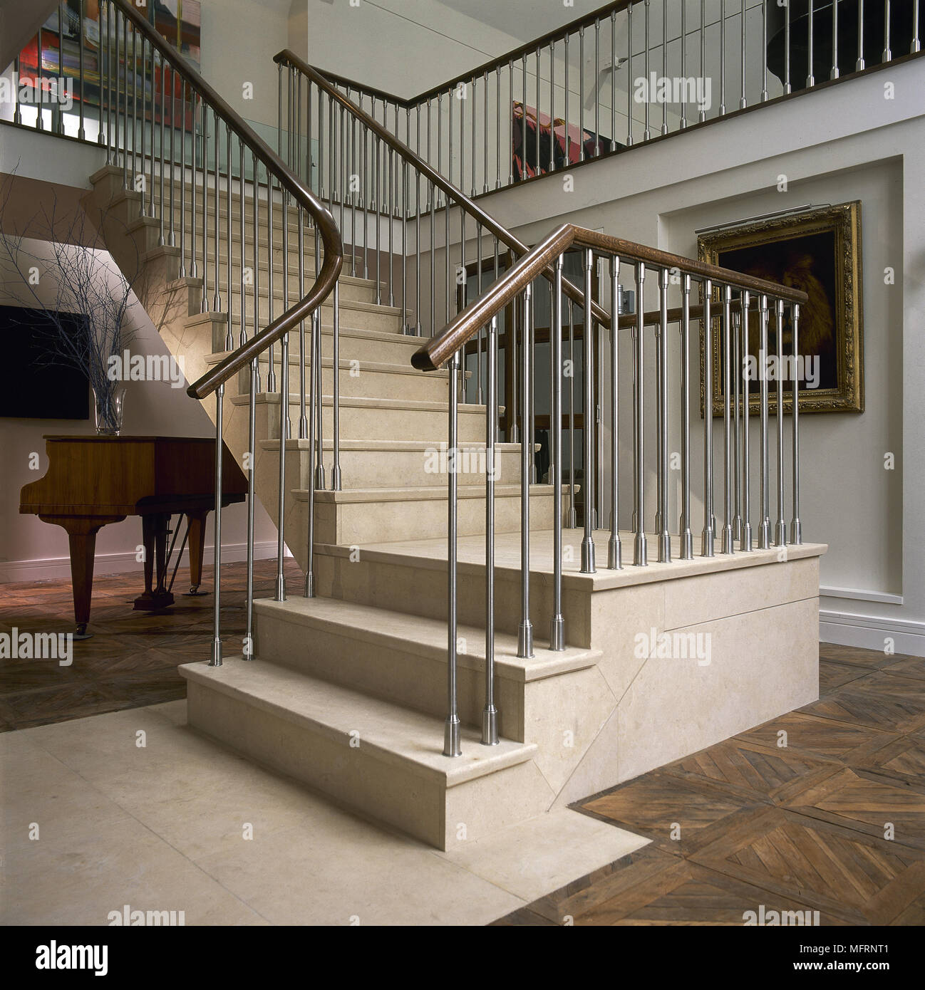 Hallway with metal staircase and stone steps leading up to gallery ...