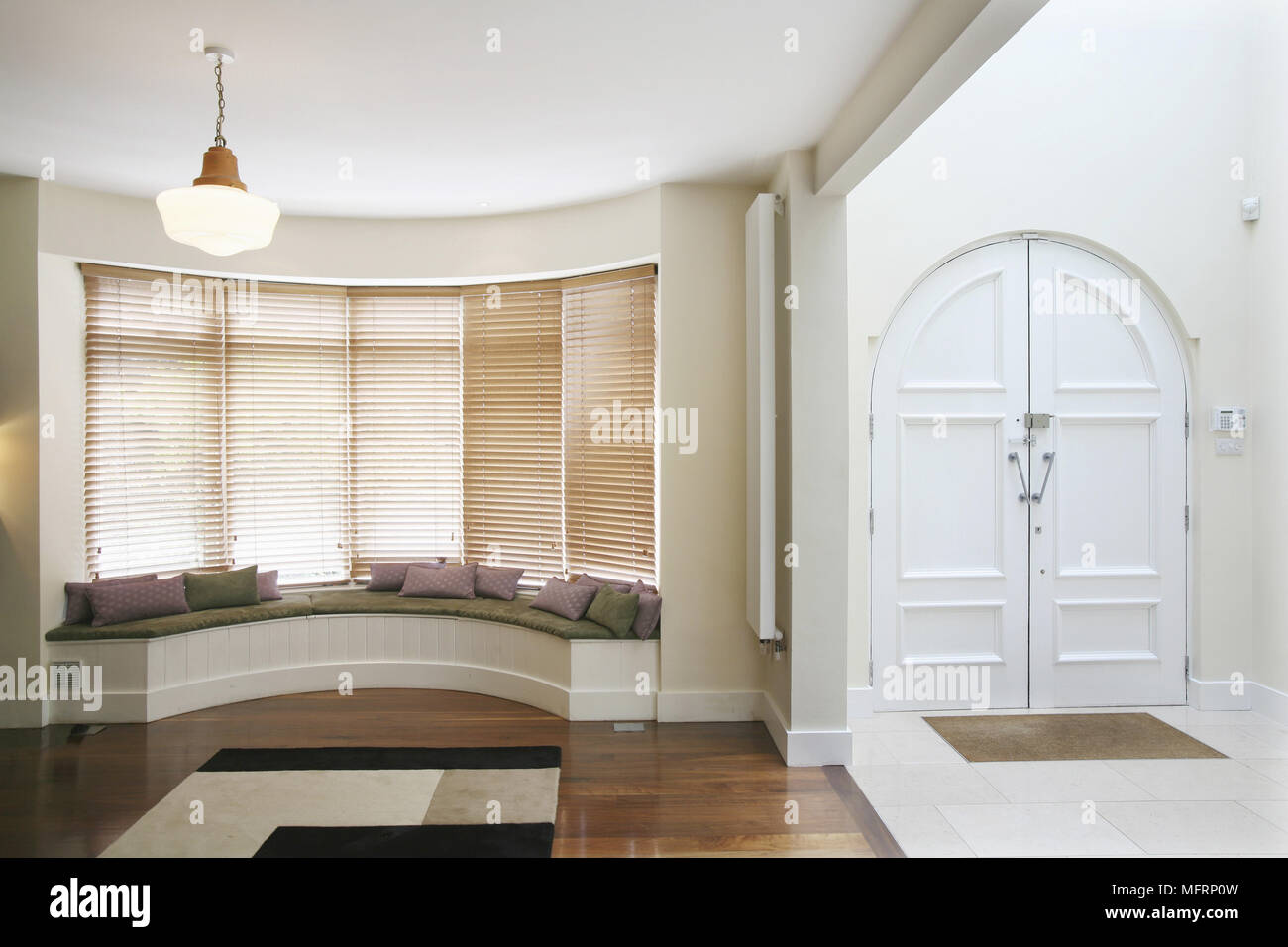 Front entrance hall with window seat set in bay window Stock Photo - Alamy