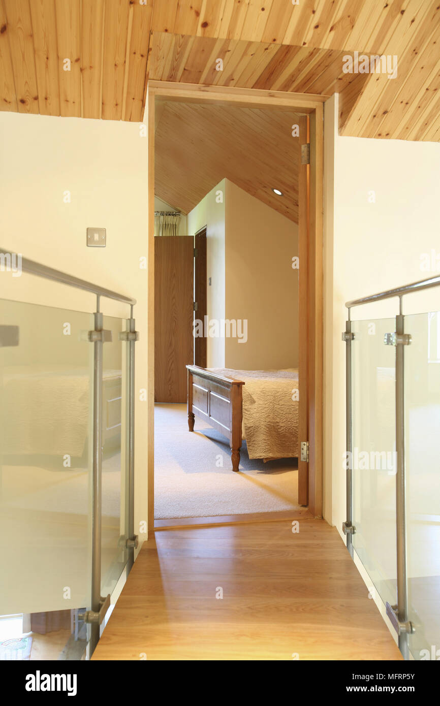 View along landing with glass panels through open door to bedroom ...