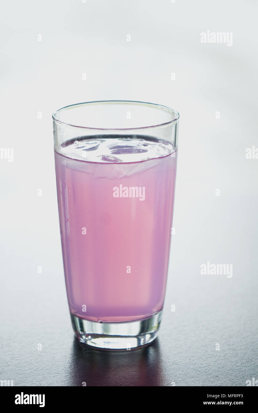 Glass drinking glass with pink liquid Stock Photo - Alamy