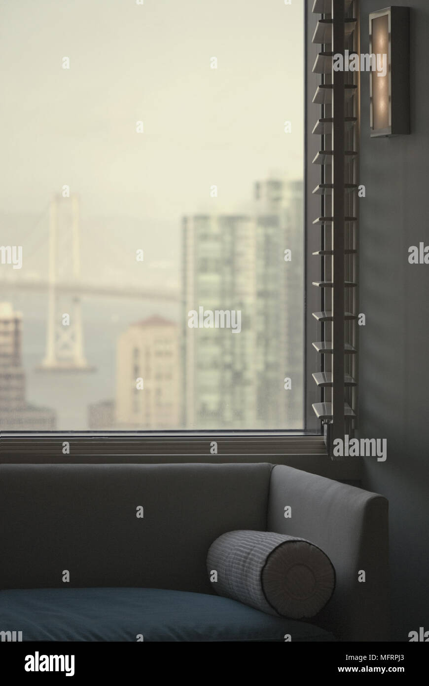 Upholstered sofa beneath window Stock Photo - Alamy