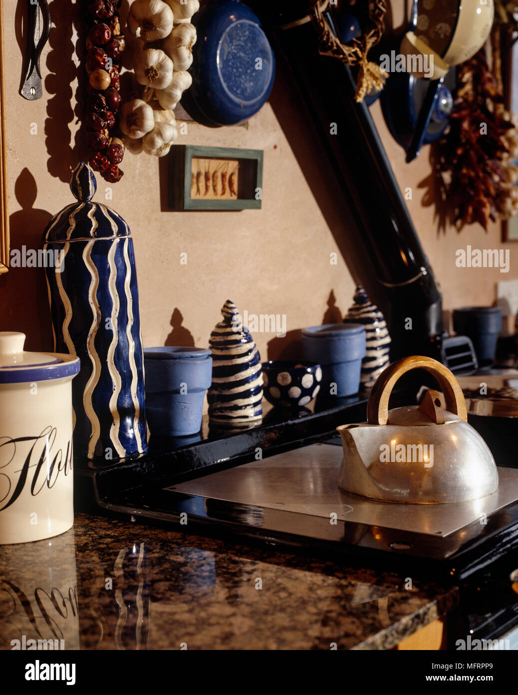 Dried peppers and garlic string hanging above kitchen stove Stock Photo ...