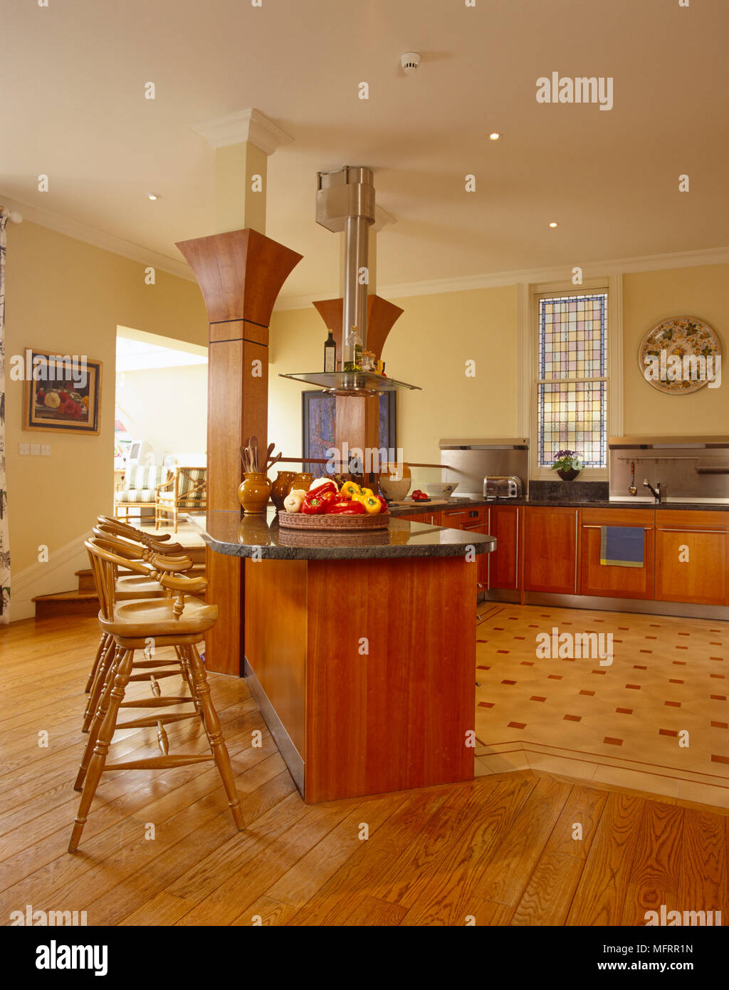 Breakfast bar and stools in kitchen with wooden fitted units Stock ...