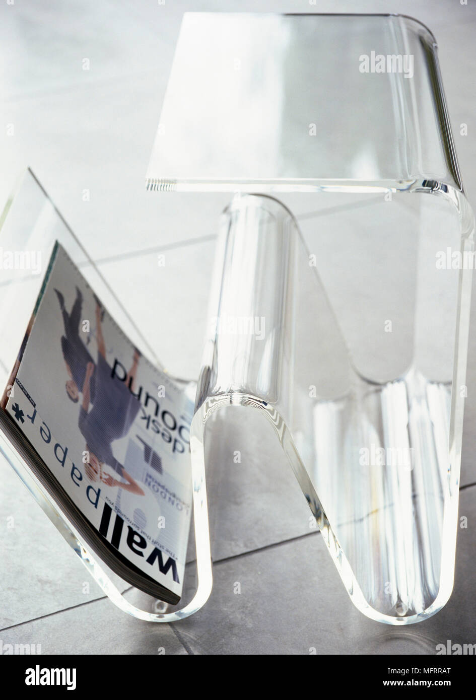 Magazine in modern plastic magazine rack Stock Photo - Alamy