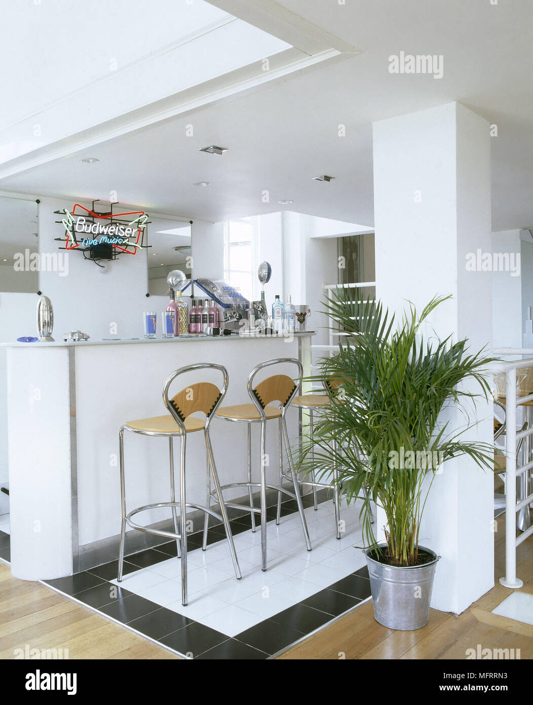 A modern open plan kitchen area with breakfast bar retro styling wood ...
