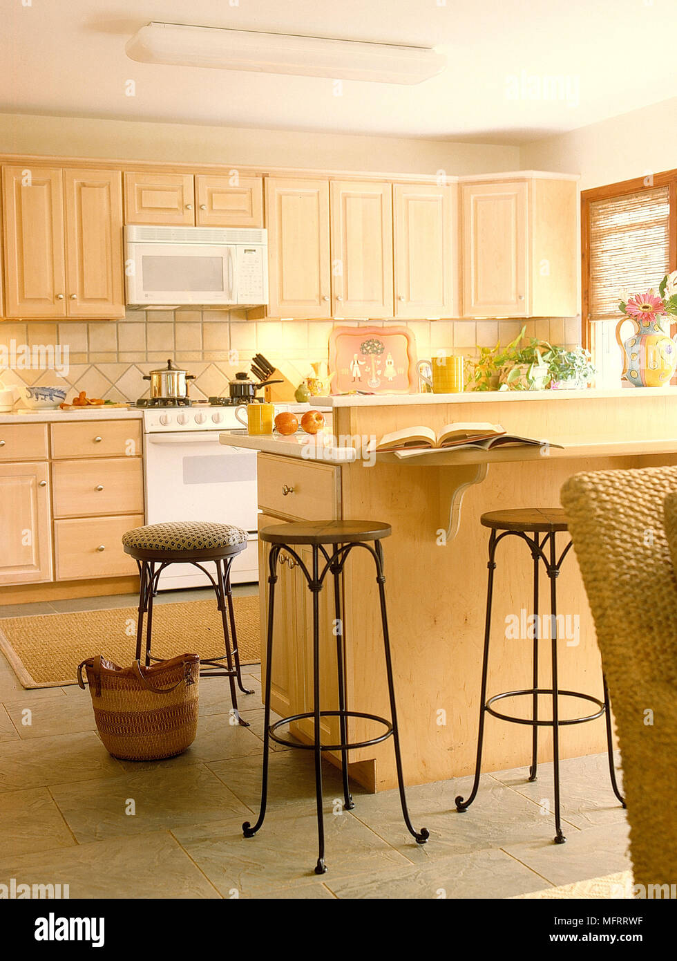Breakfast bar in kitchen with wooden units Stock Photo - Alamy