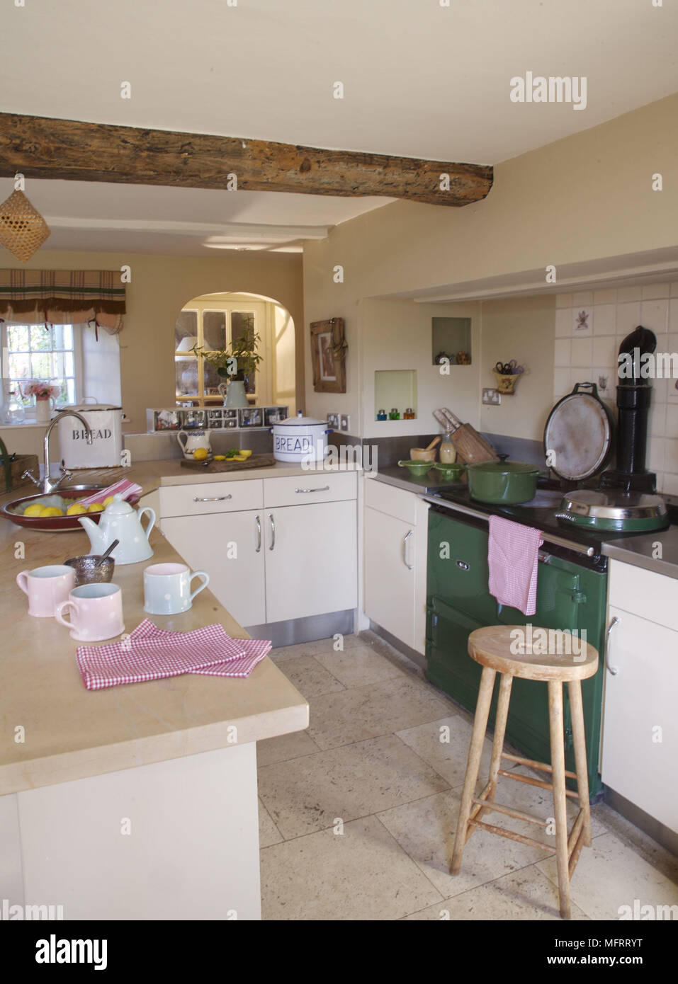 Country style kitchen with green Aga Stock Photo - Alamy
