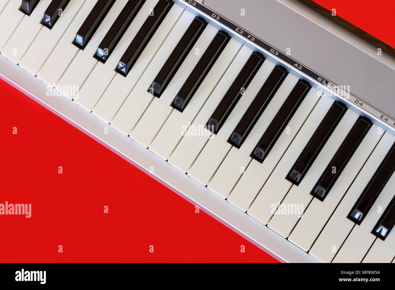 Top view on digital piano keyboard on the red bacground Stock Photo - Alamy