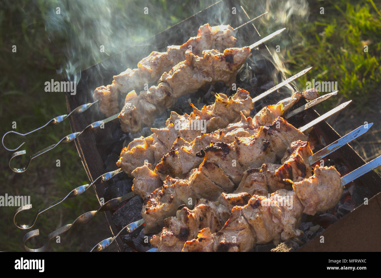 Bbq kebab grilling on open grill, outdoor kitchen Stock Photo - Alamy