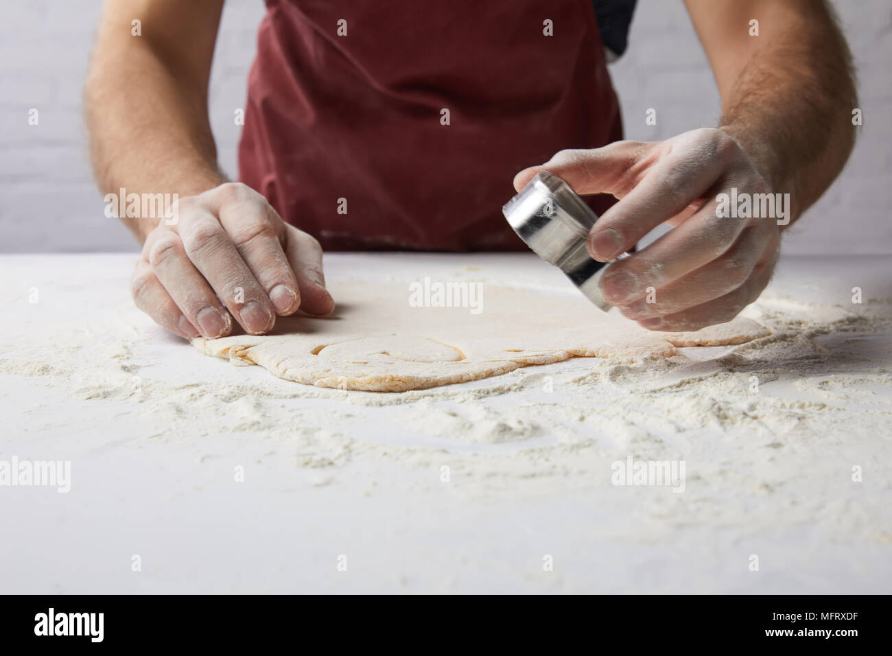cropped image of chef preparing heart shaped cookies with dough mold ...