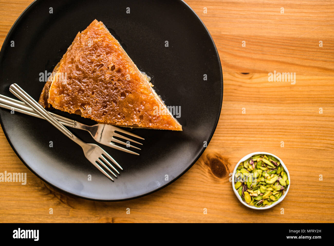 Turkish Traditional Dessert Ekmek Kadayifi / Bread Pudding on a wooden ...