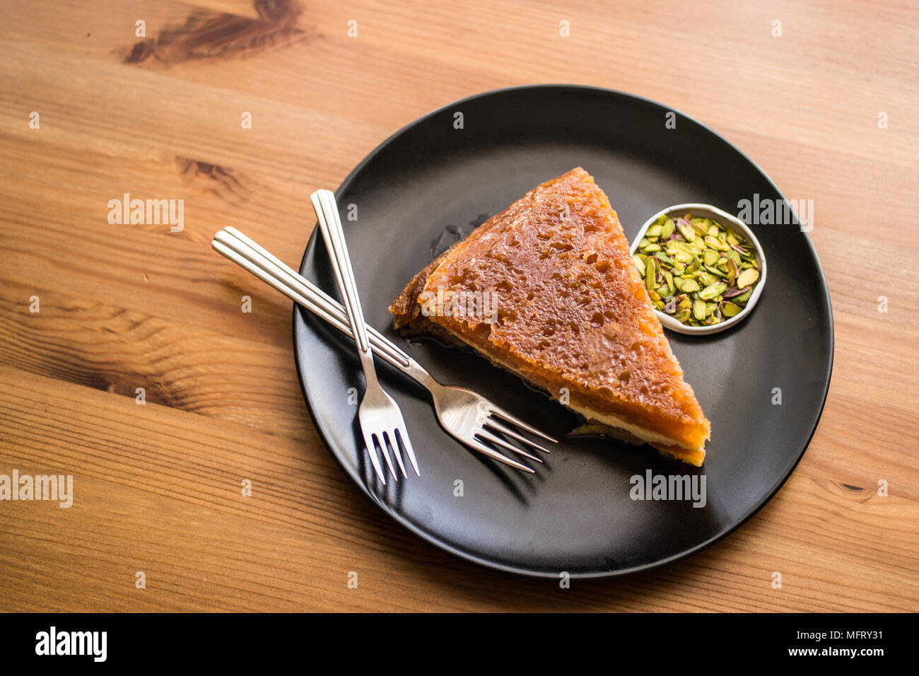 Turkish Traditional Dessert Ekmek Kadayifi / Bread Pudding on a wooden ...