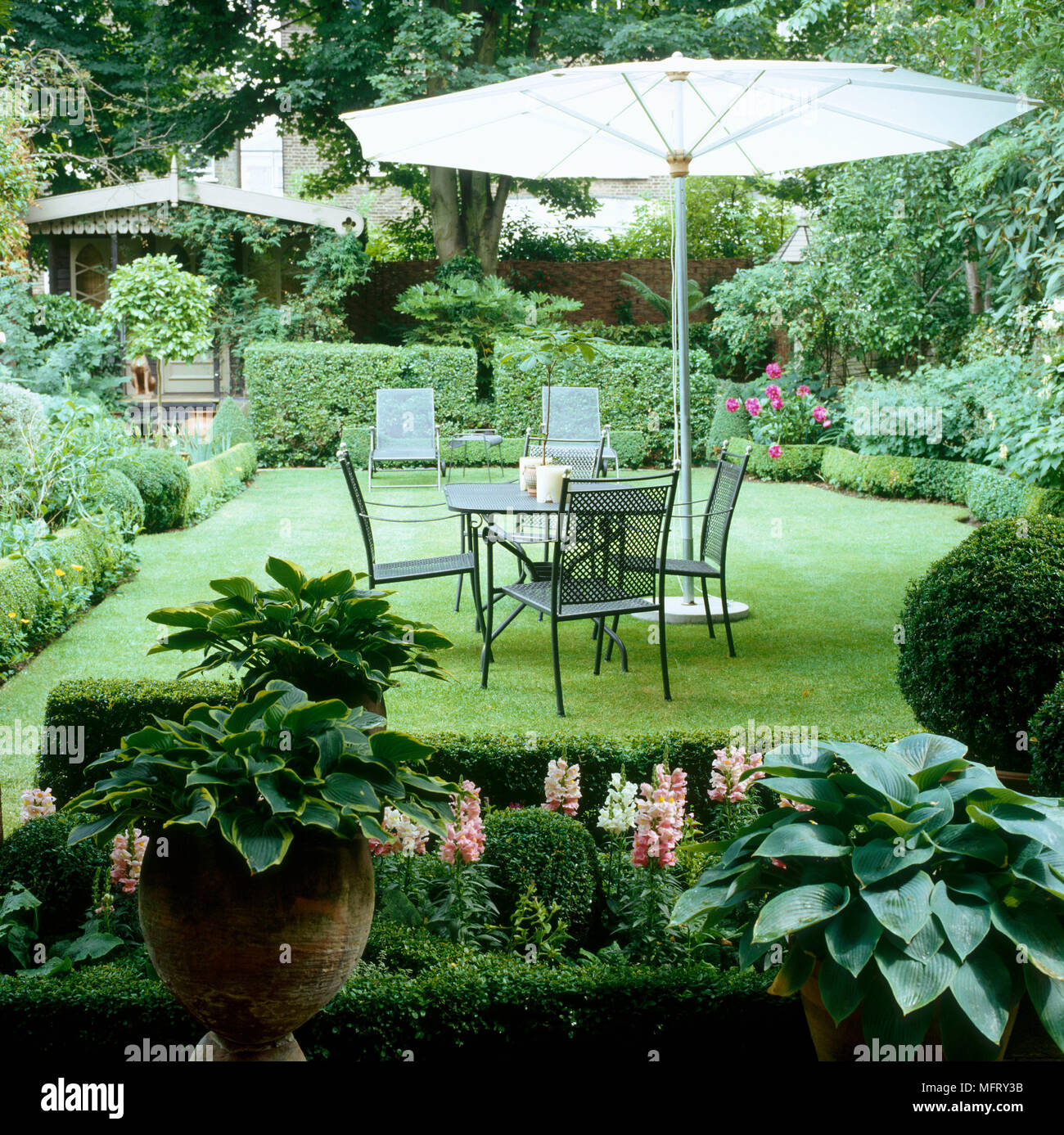 A county garden with table and chairs set out on the lawn surrounded by ...