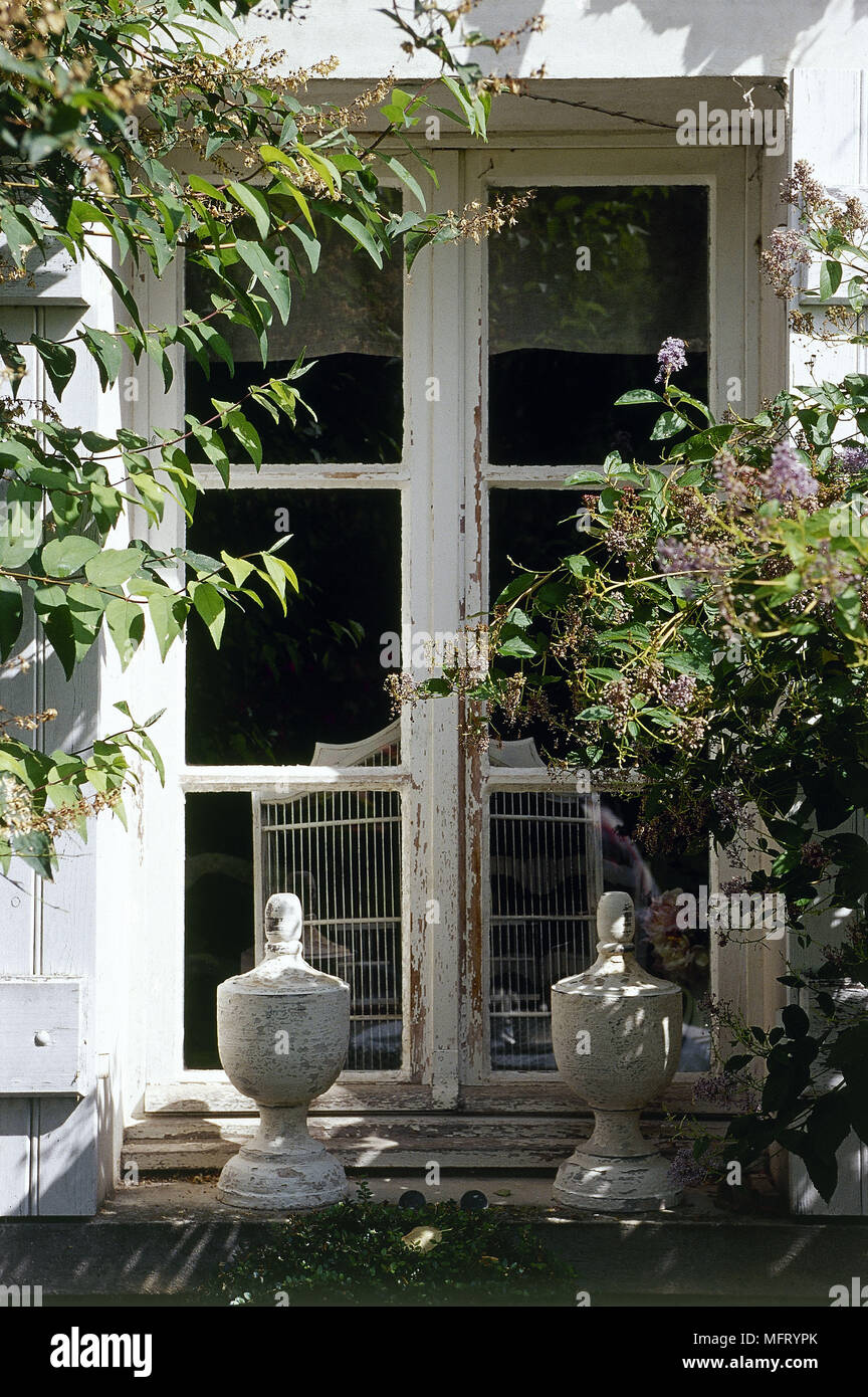 Rustic window detail windows stone urns Stock Photo - Alamy