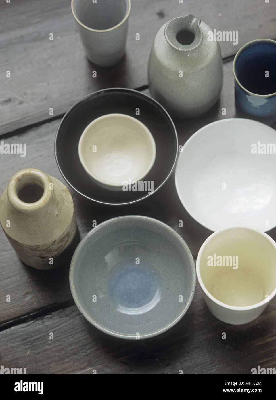 Overhead view of ceramic objects on dark timber boards Stock Photo - Alamy