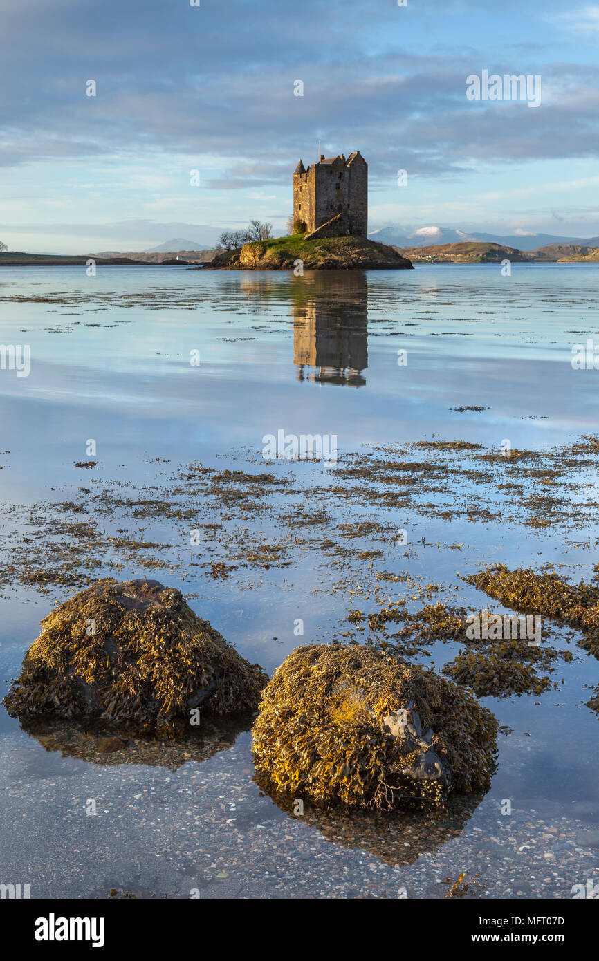 Castle Stalker at sunrise in winter. A castle surrounded by water on ...