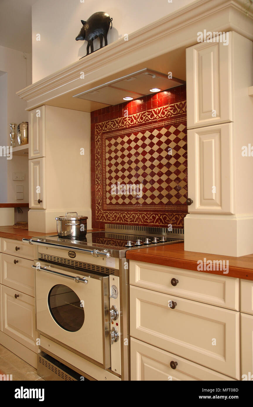 Modern country style kitchen with fitted oven with tiled splashback ...