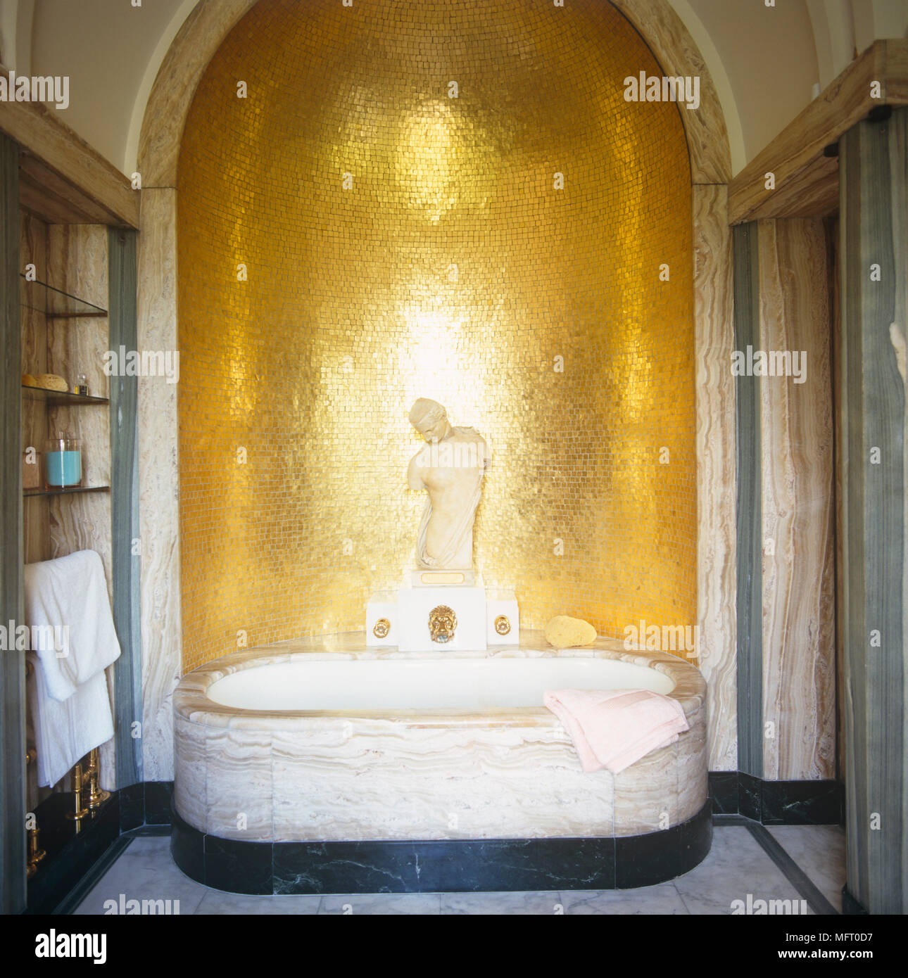 Classical style statue above freestanding bathtub in opulent bathroom ...