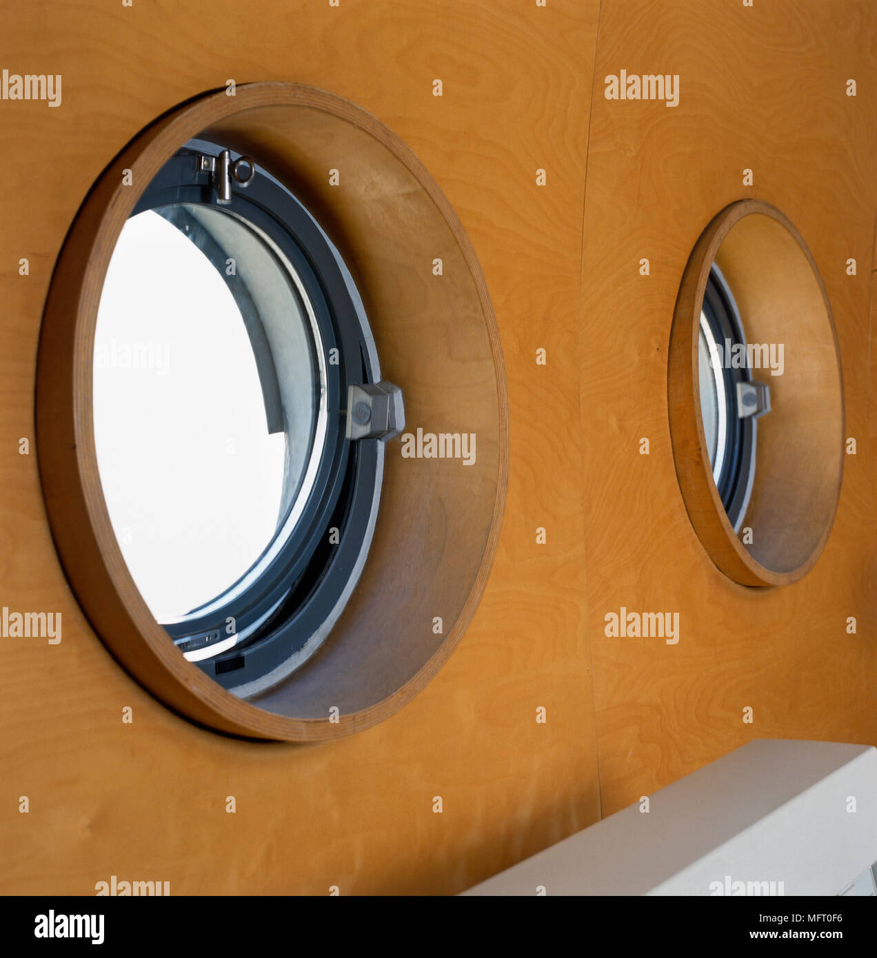 Pair of porthole windows in wooden panelled wall Stock Photo - Alamy