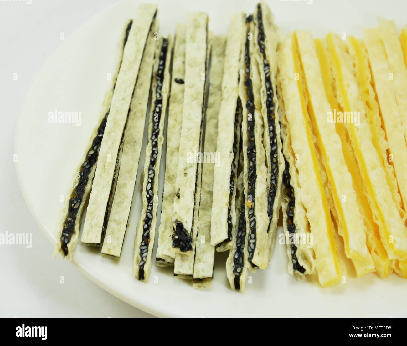 fish snack line filling cheese and black sesame on dish Stock Photo - Alamy