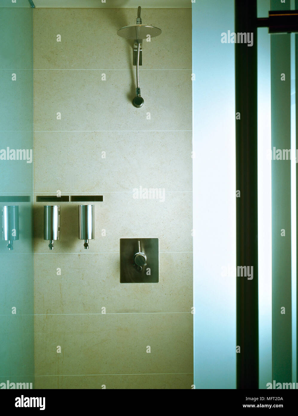 A detail of a modern bathroom showing shower cubicle, neutral tiling ...