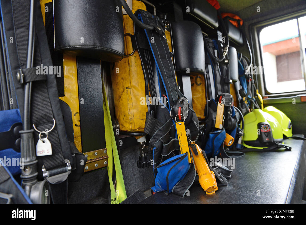 Inside the back seat of a fire engine with helmets and breathing ...