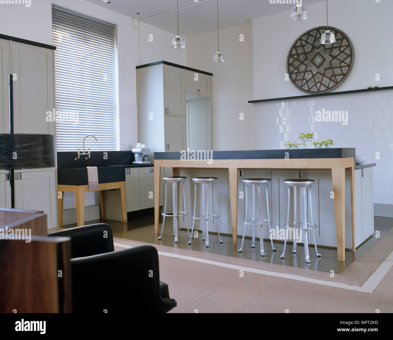 Four bar stools at breakfast bar in white contemporary open plan ...