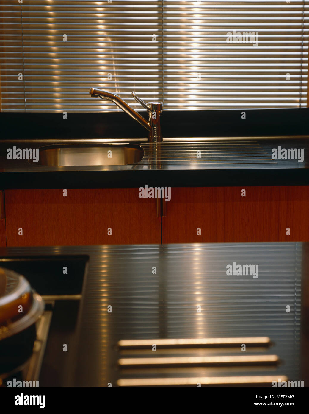 Stainless steel sink with closed venetian blinds behind Stock Photo - Alamy