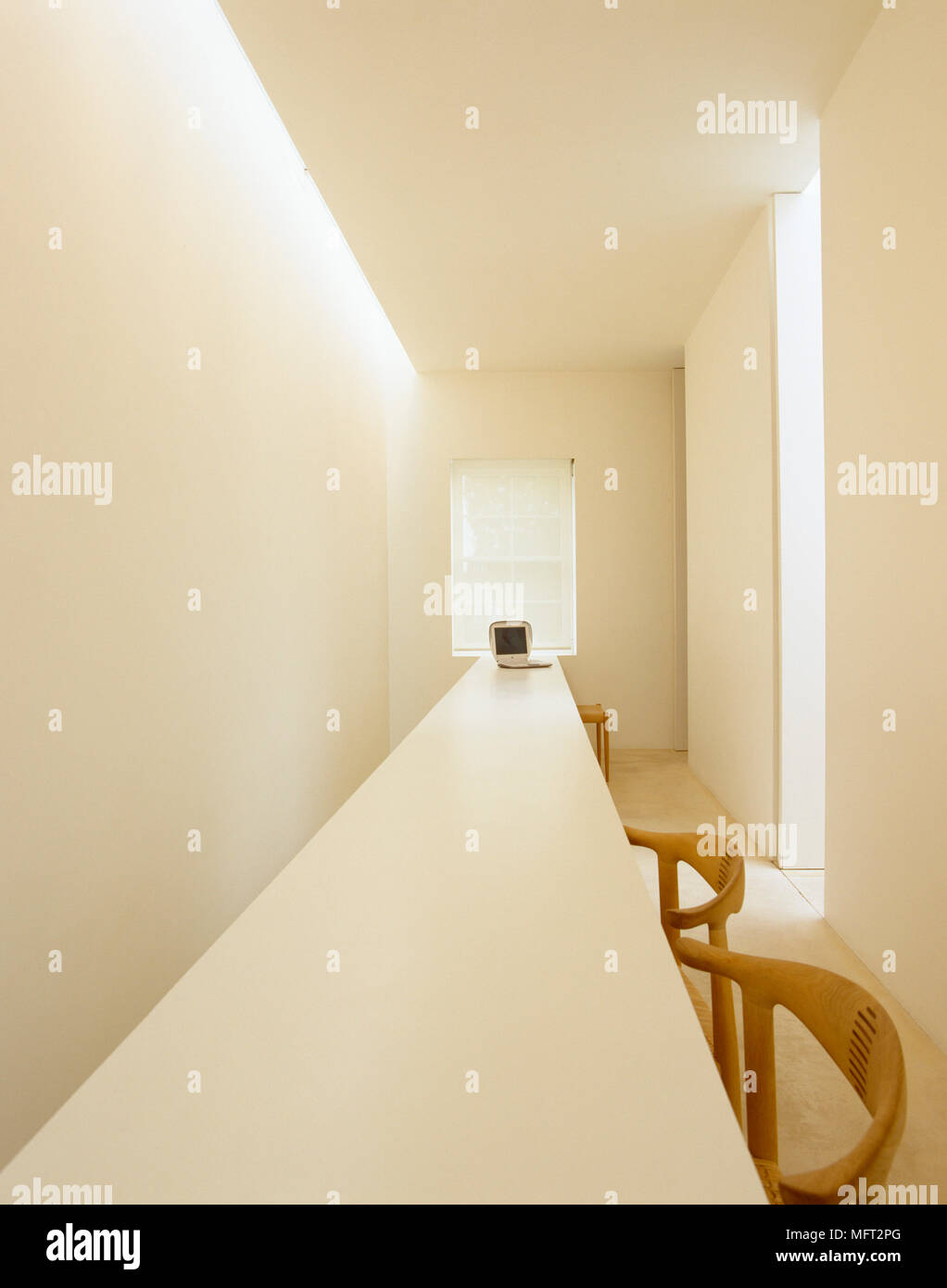 Lap top computer on long table in minimalist room Stock Photo - Alamy