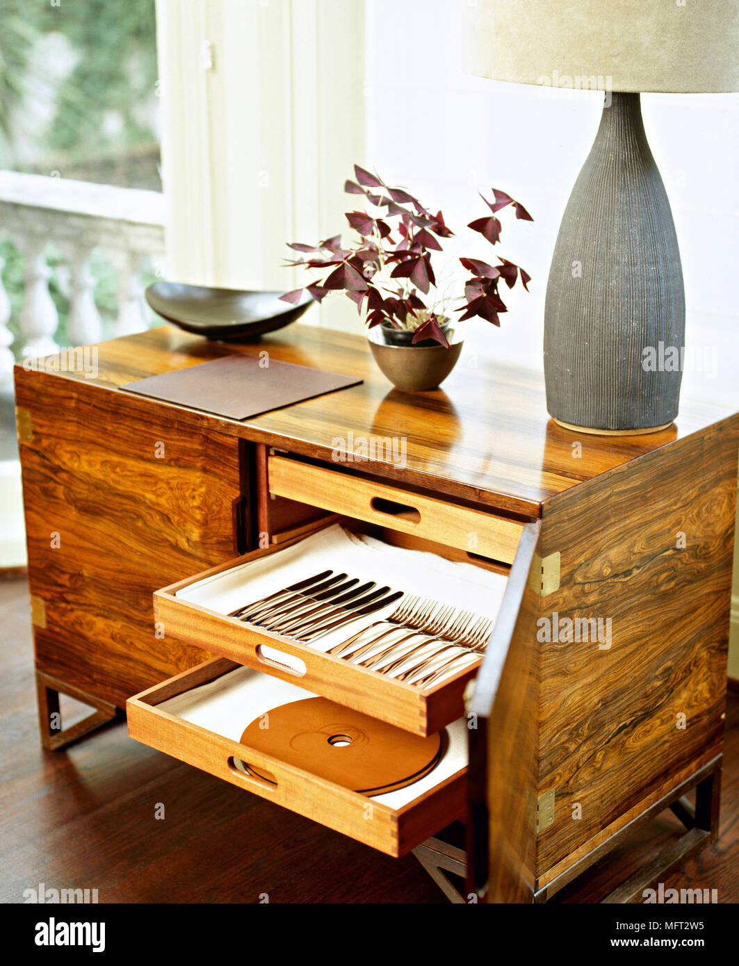 Wood side unit with open drawers storing cutlery Stock Photo - Alamy
