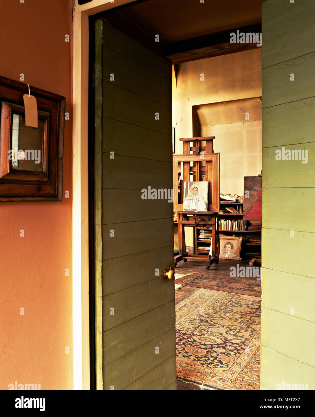 View through doorway to artists studio beyond wood panelling interiors ...