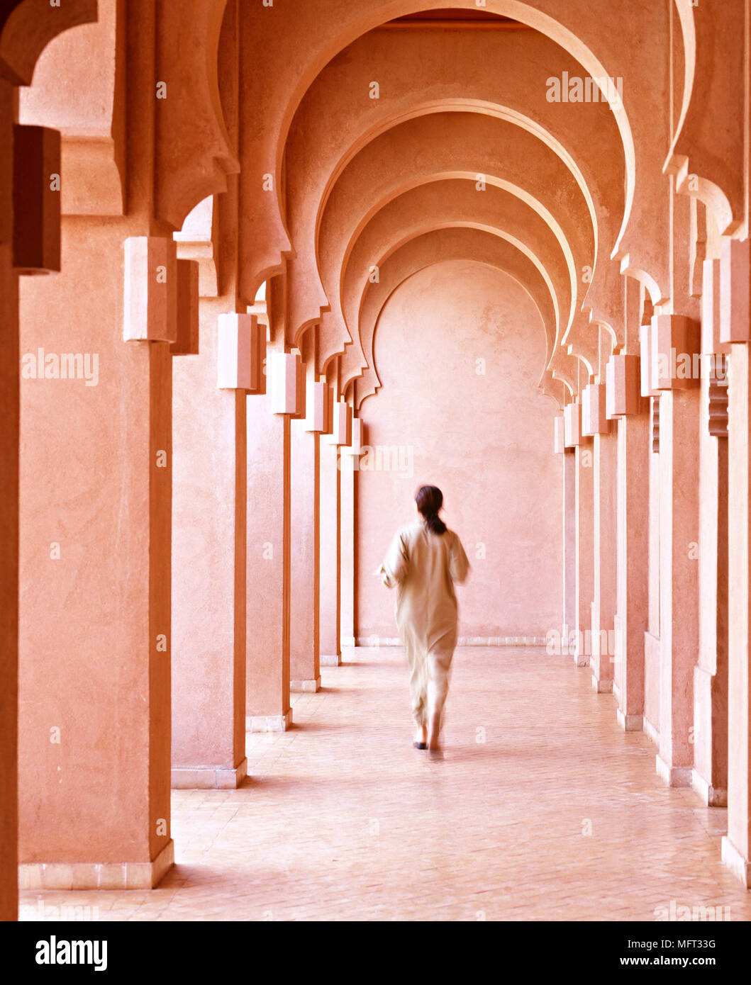 Person walking along cloistered walkway in Moroccan house Interiors ...