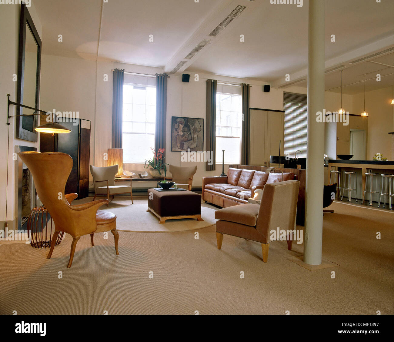 Modern open plan sitting room brown leather armchairs and sofa circular ...
