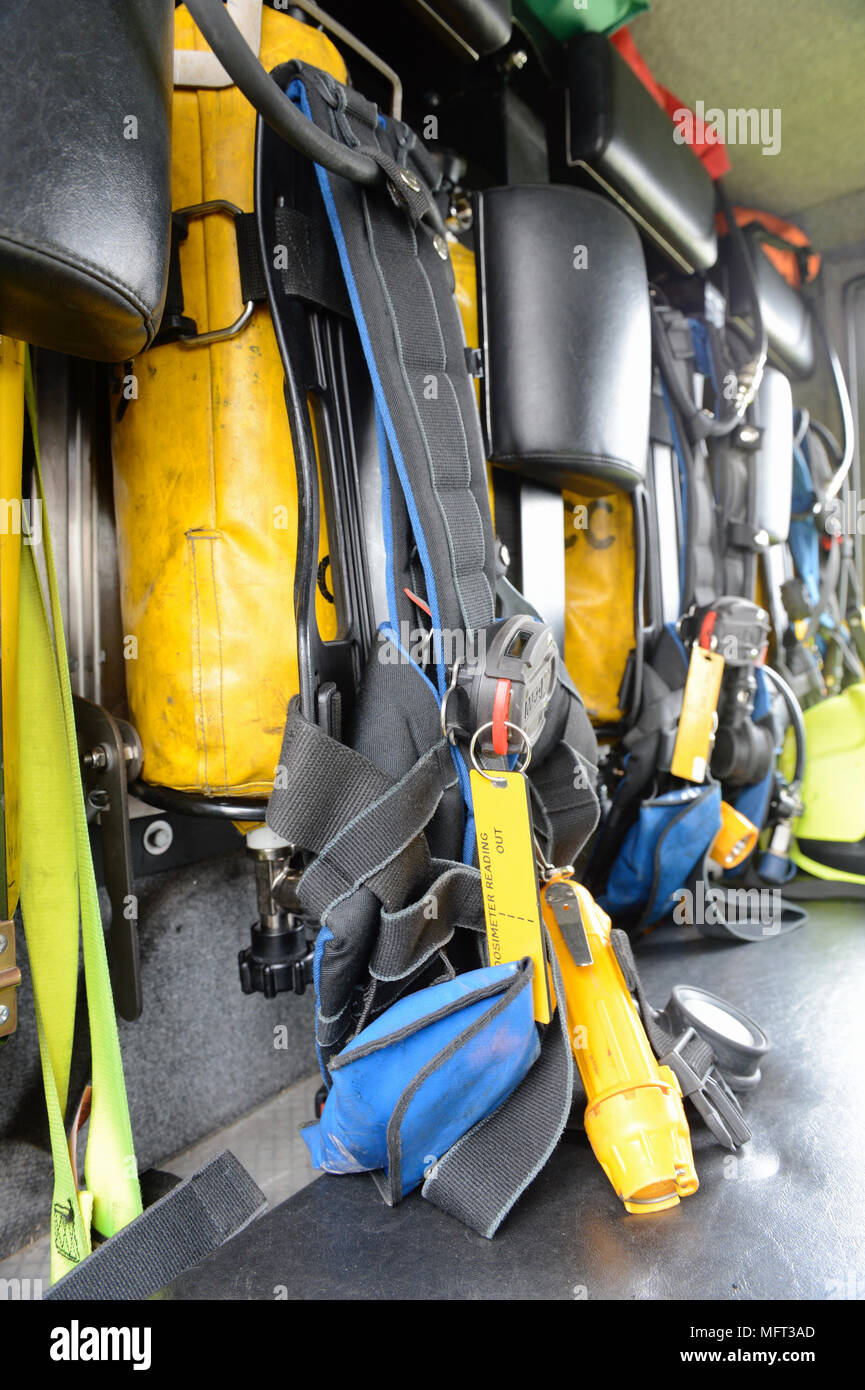 Inside the back seat of a fire engine with helmets and breathing ...