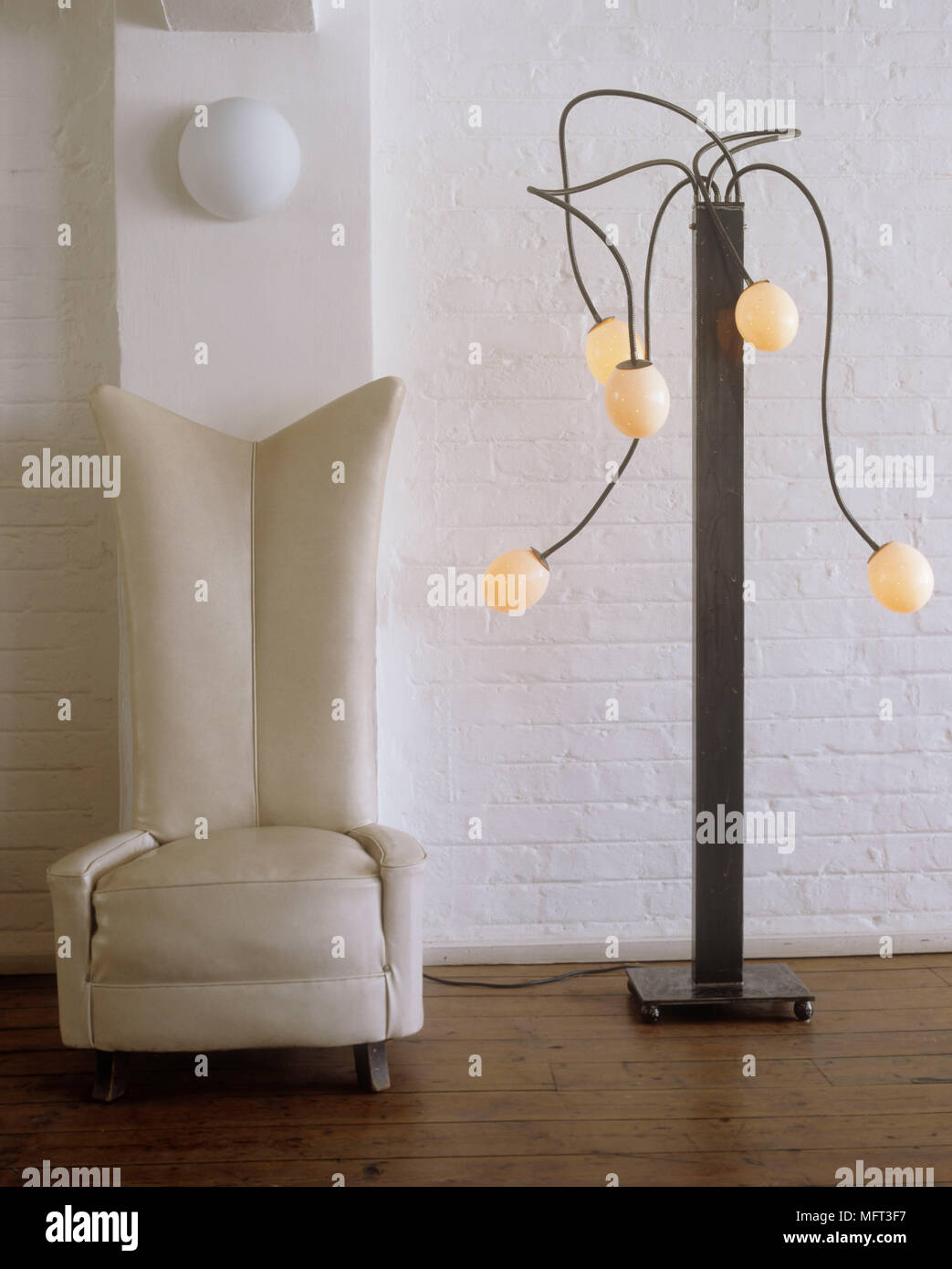 Leather armchair next to floor lamp Stock Photo - Alamy