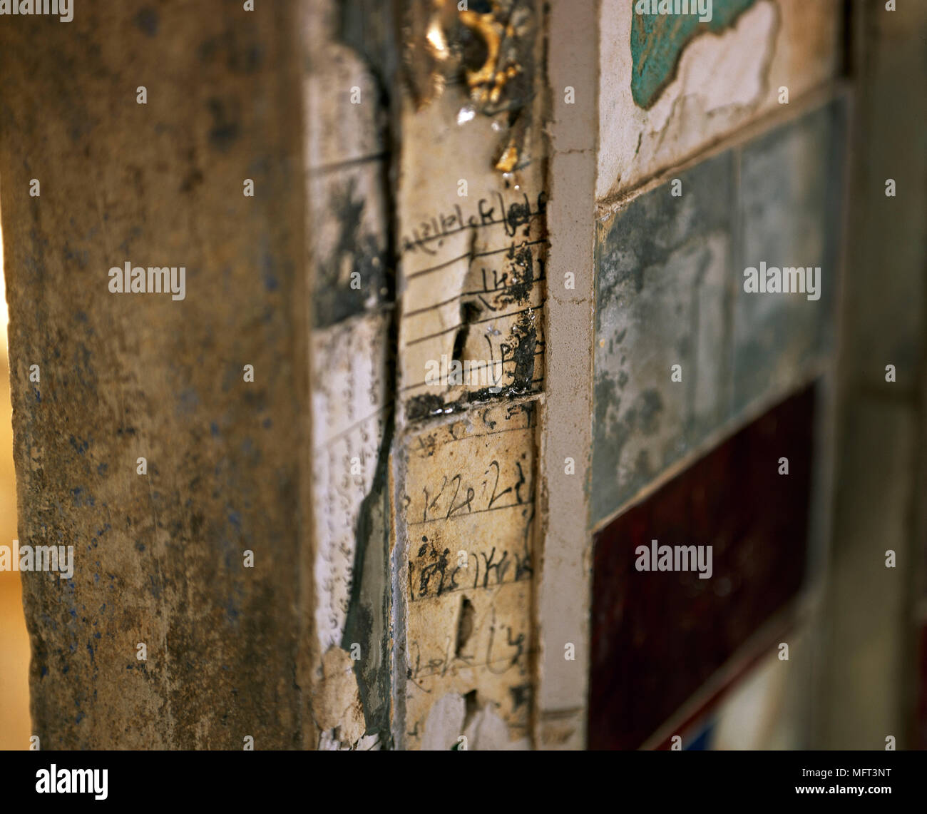 Close up of distressed wall tiled wall tiles with text interiors detail ...