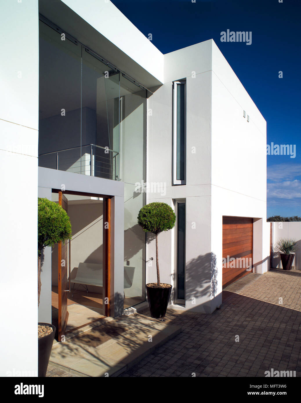 An exterior of a modern white washed house with integral garage double ...