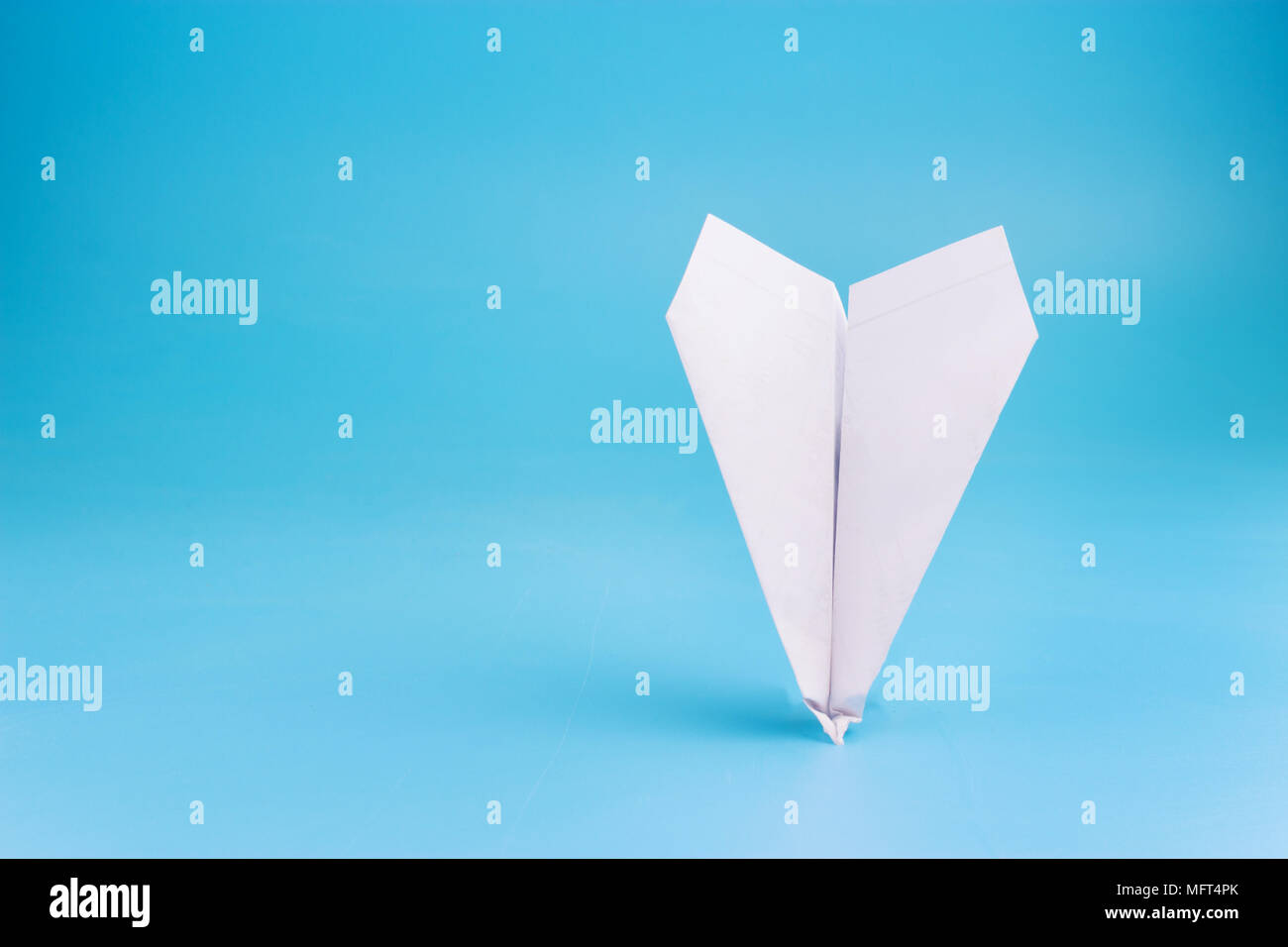 plane crash concept. paper plane upside down on blue background Stock ...
