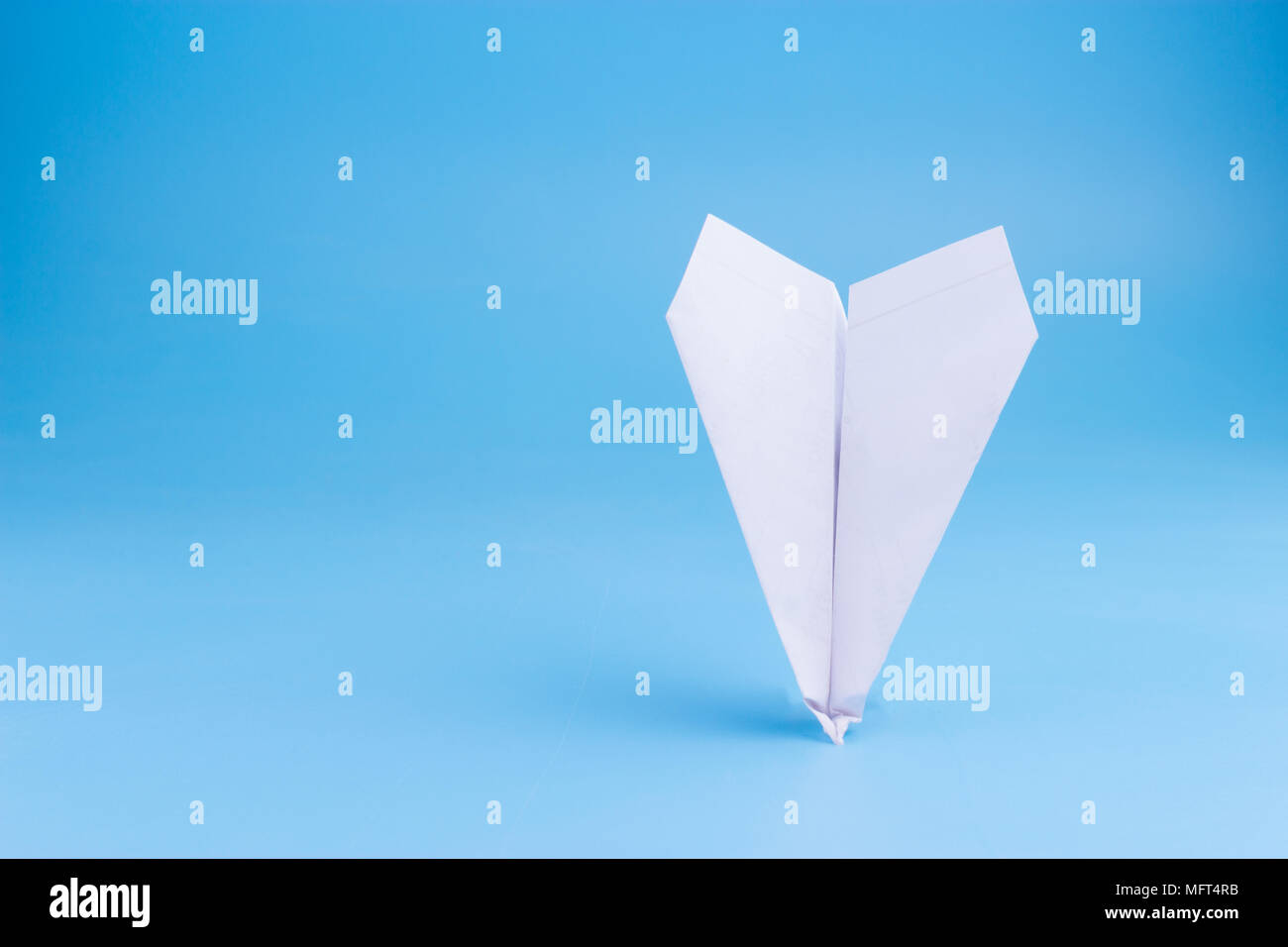 plane crash concept. paper plane upside down on blue background Stock ...