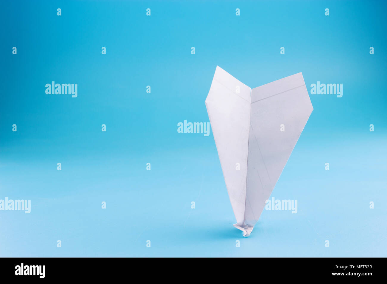 plane crash concept. paper plane upside down on blue background Stock ...