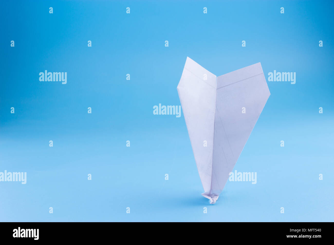 plane crash concept. paper plane upside down on blue background Stock ...