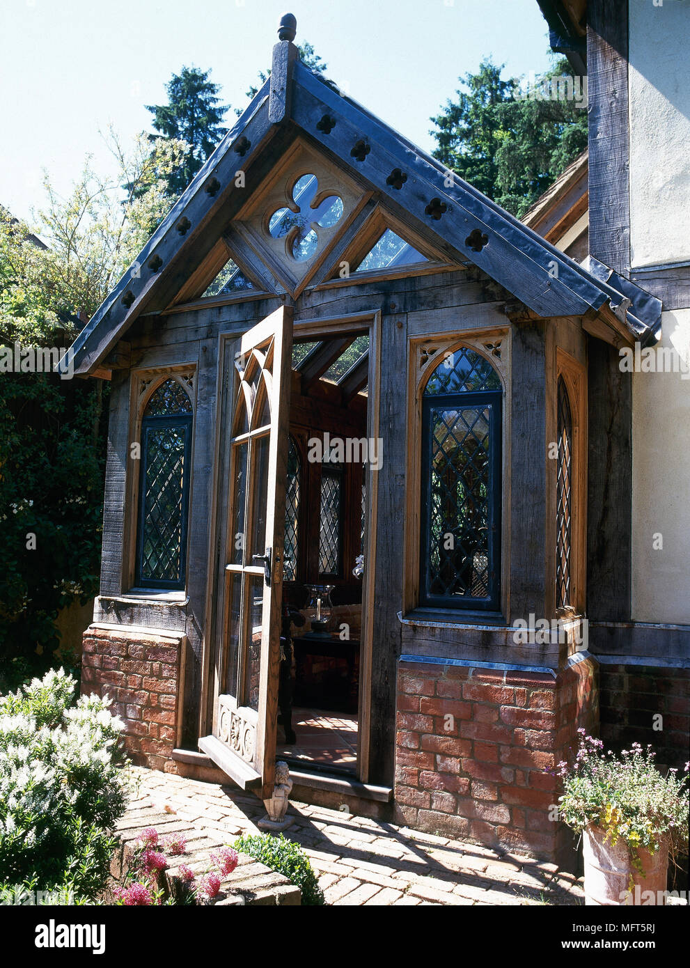 An exterior of a carved, timber and brick entrance porch with gothic ...