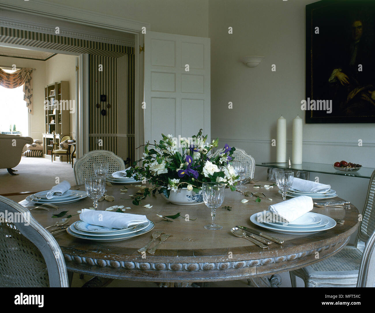 A traditional dining room with round table, set for dinner Stock Photo ...