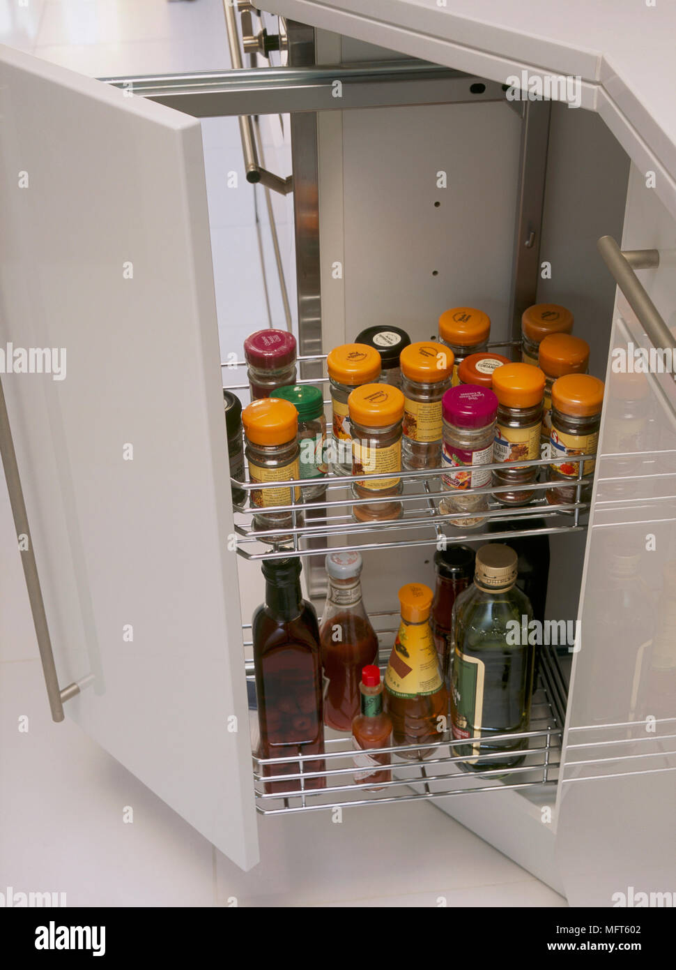 A detail of a modern kitchen showing a pull out storage unit with food ...