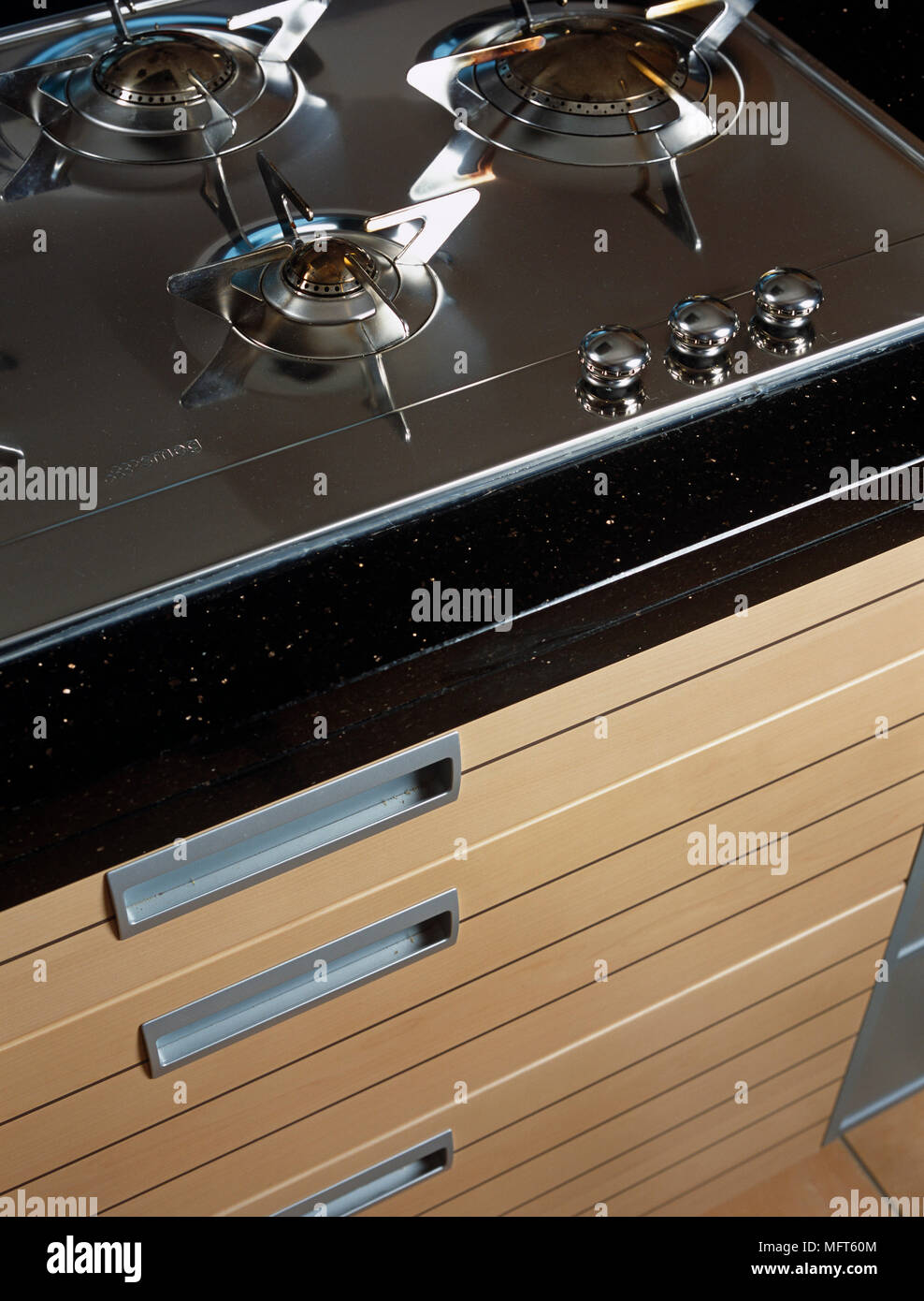 Gas hob set in kitchen unit with drawers below Stock Photo - Alamy