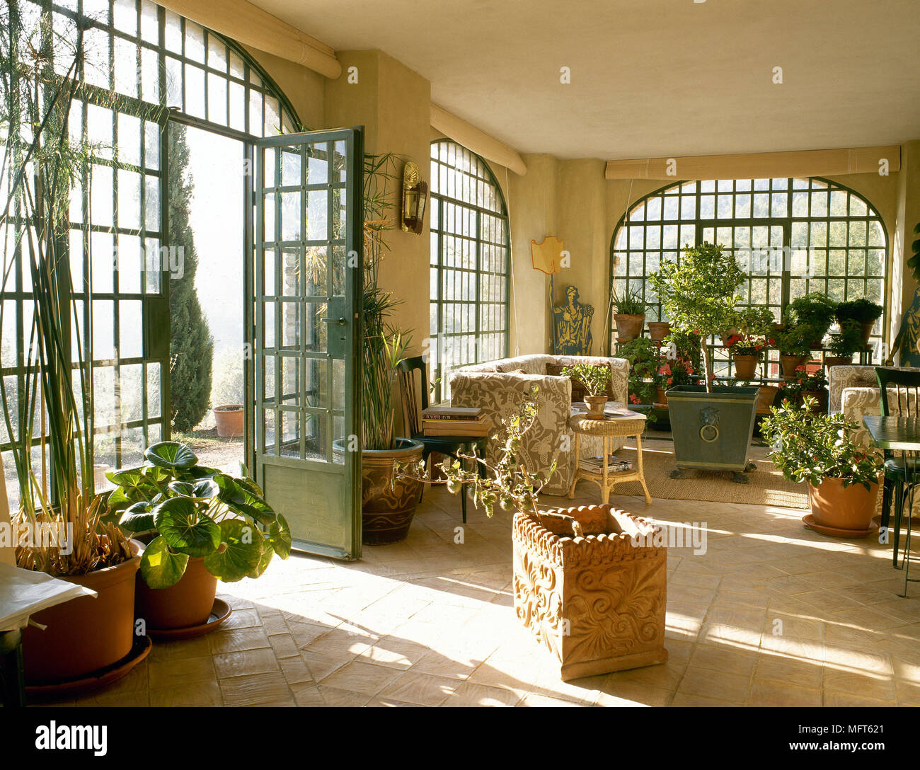 Country style conservatory garden room with tiled floor and sunlight ...