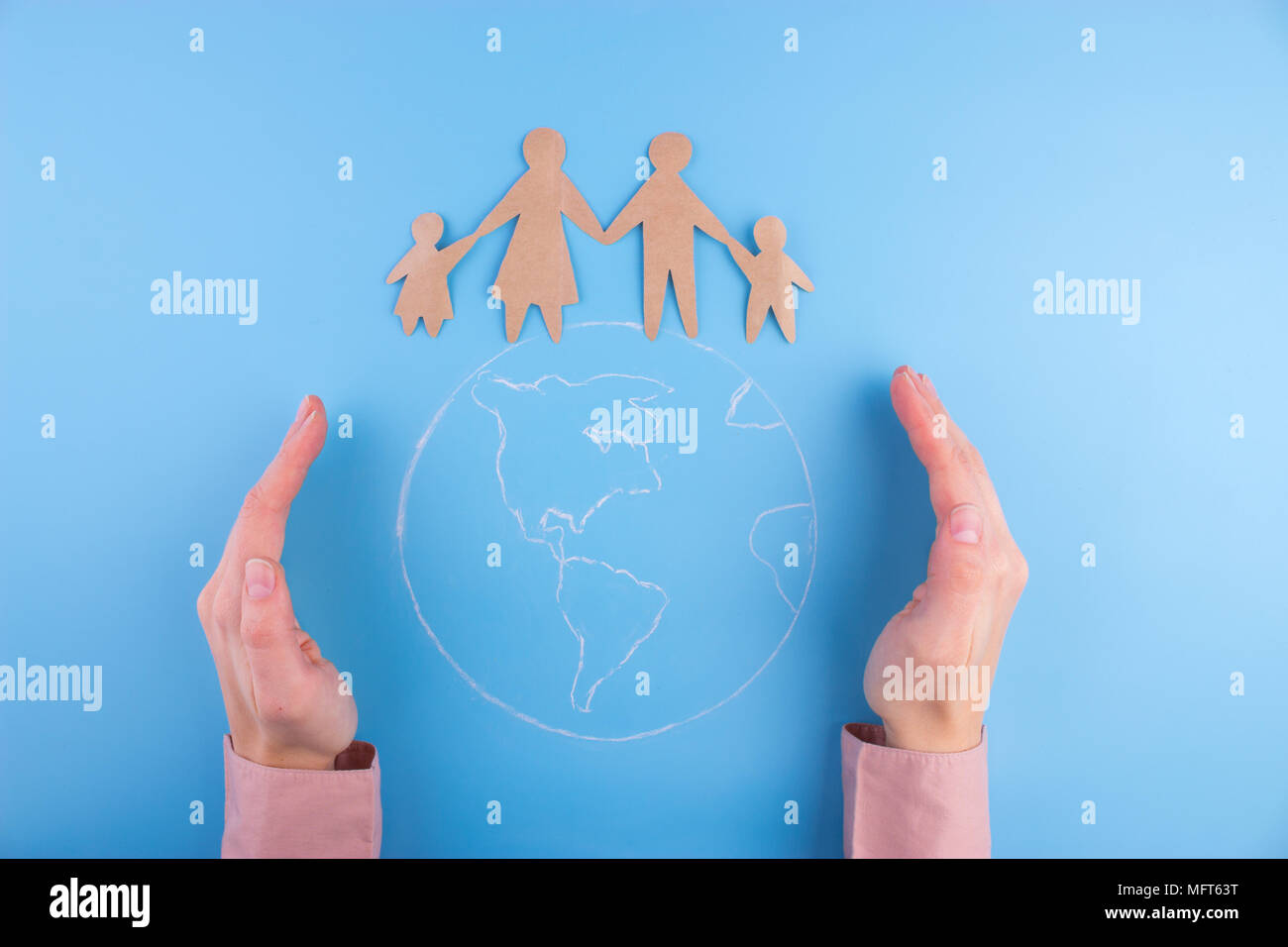 paper family on the earth planet. family and peace concept Stock Photo ...