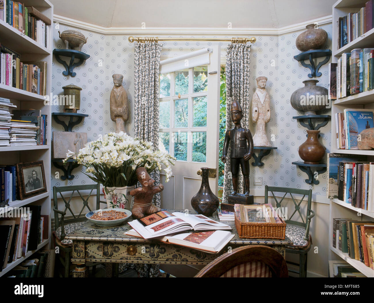 A traditional library room, study with book shelves, decorated table ...