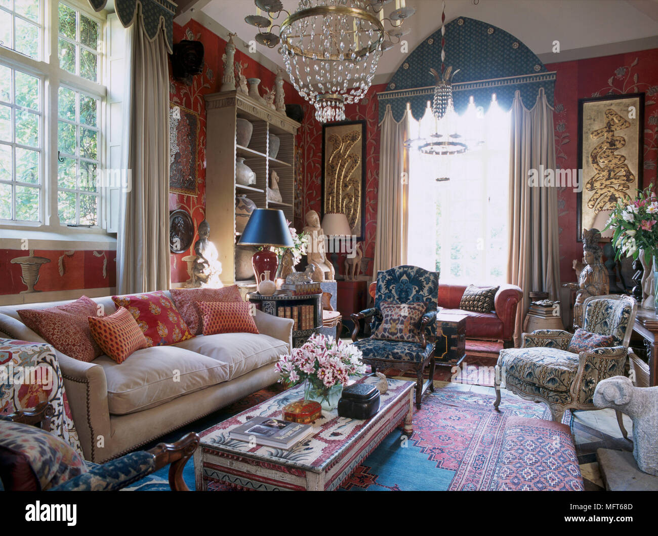 A traditional, red sitting room decorated in an opulent style with rich ...