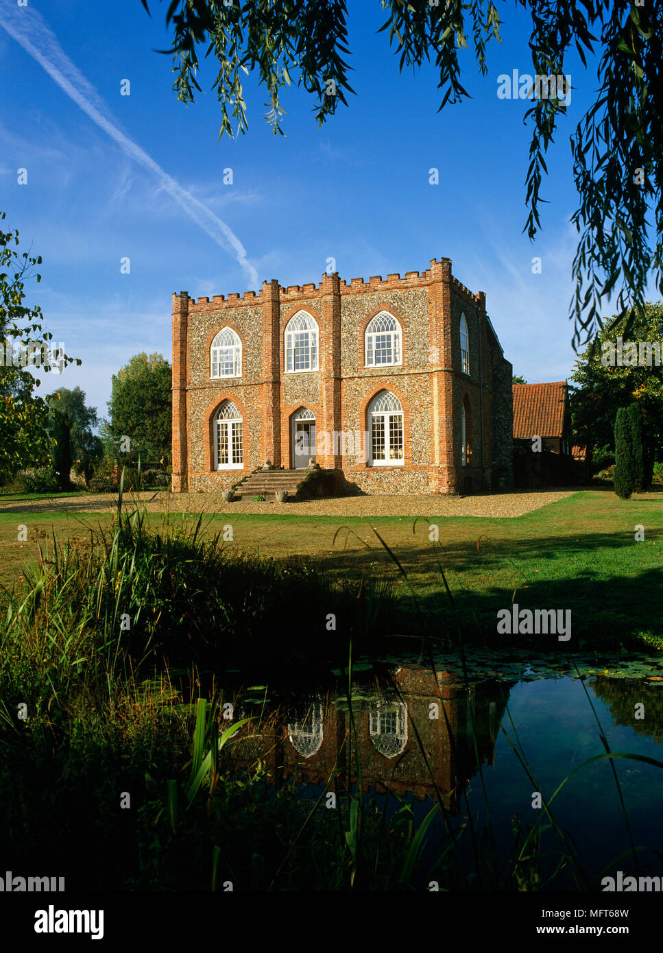 Exterior of a castellated brick and flint country house with gothic ...